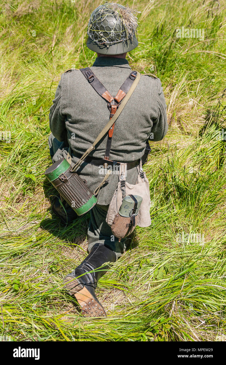 German soldier squatting on a lawn Stock Photo - Alamy