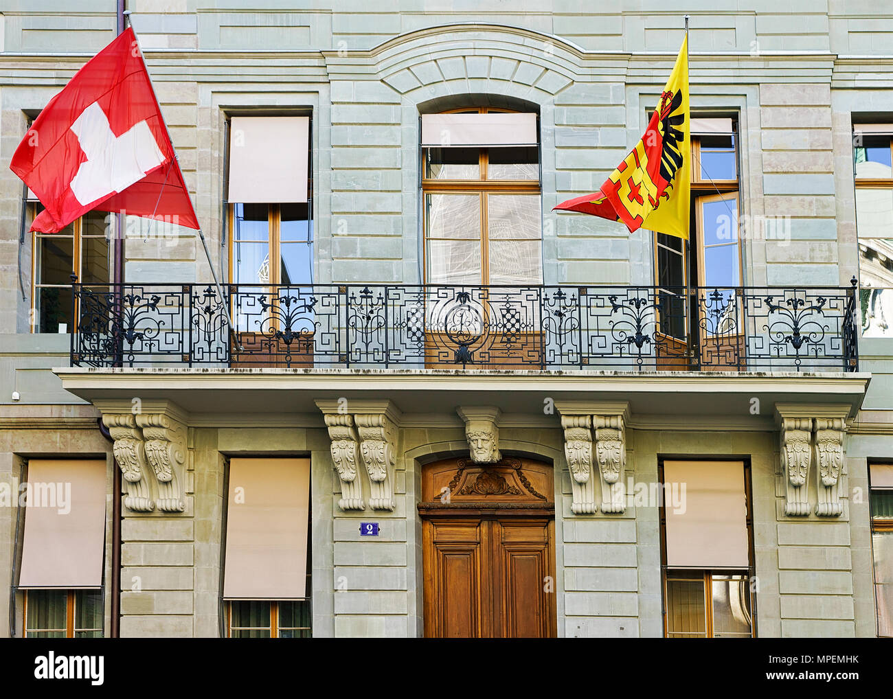 Geneva, Switzerland - August 30, 2016: Flags on the building Rue Puits ...