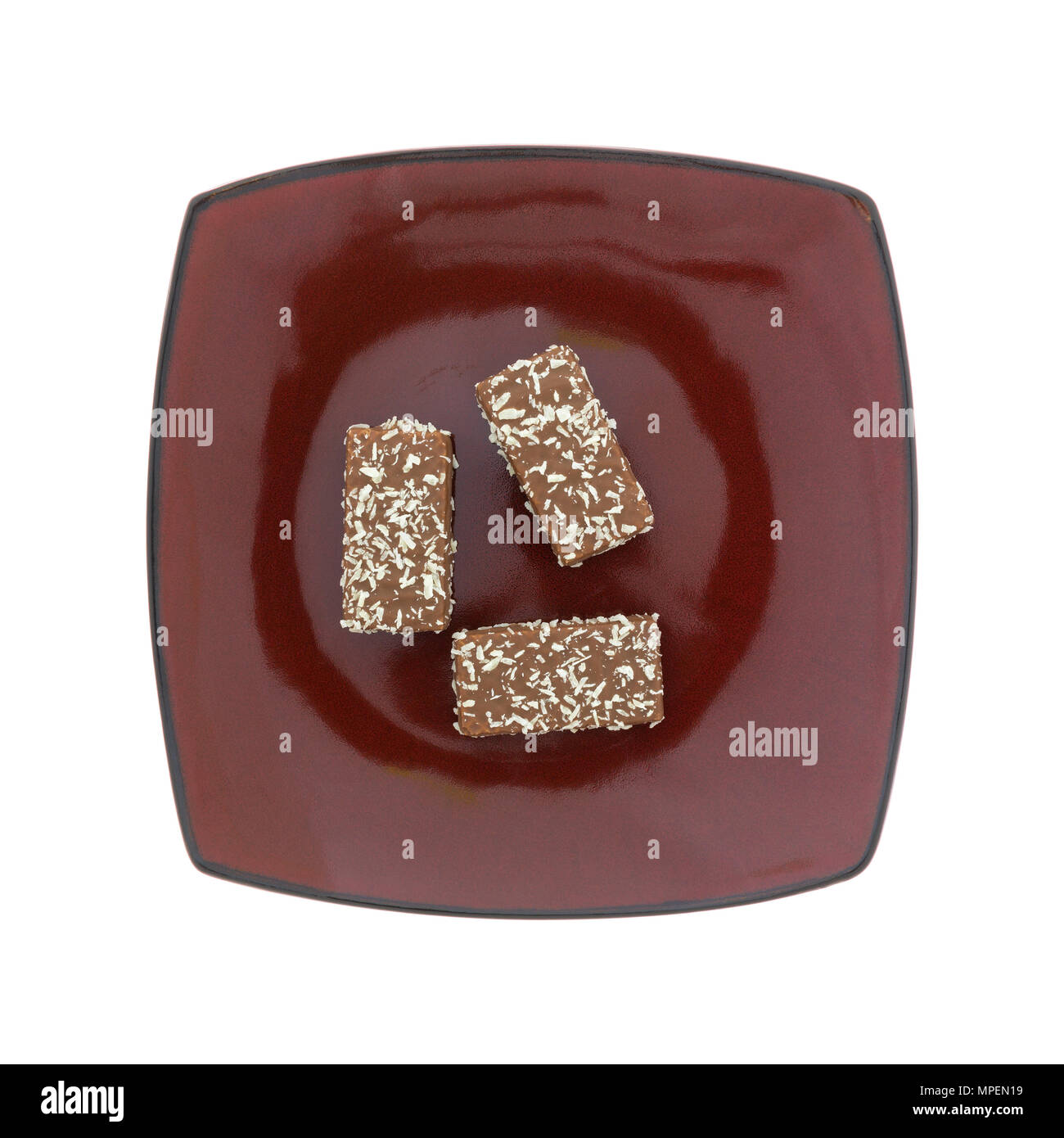 Top view of three chocolate wafer cookies with coconut flakes on a ...