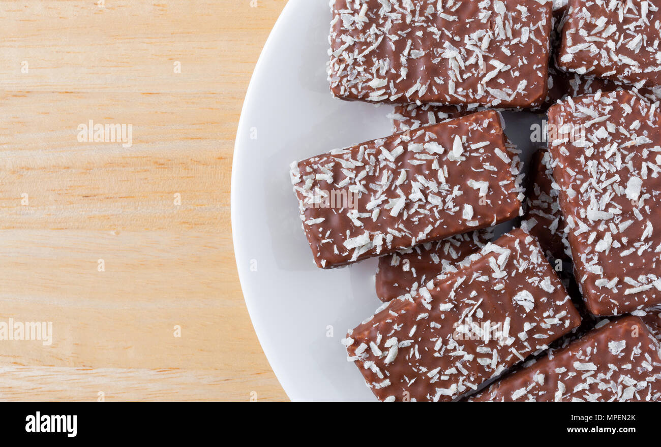 Top close view of several chocolate wafer cookies with coconut flakes ...