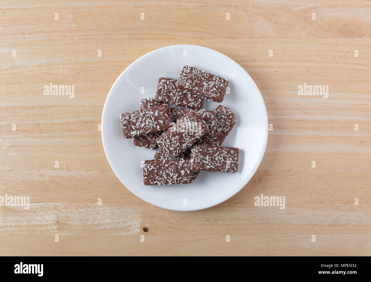 Top view of several chocolate wafer cookies with coconut flakes on a ...