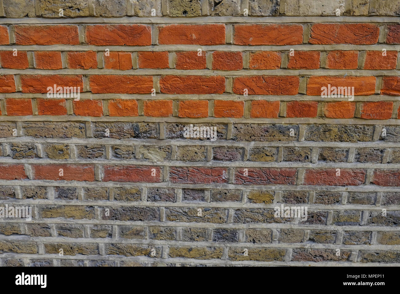 Close up of a brick wall, with layers of red and yellow bricks, an ...