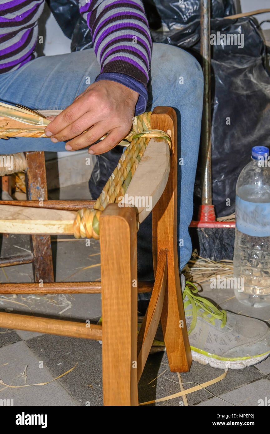 Man sitting making a wooden and rush Cypriot traditional chair Stock ...