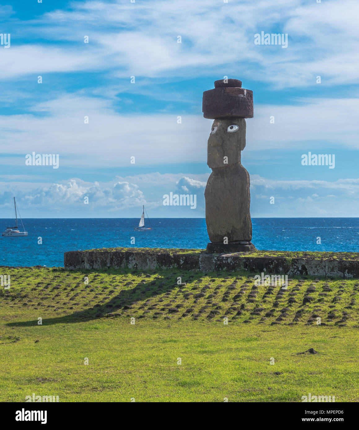 A large Moai statue with open eyes dominates the landscape Stock Photo ...