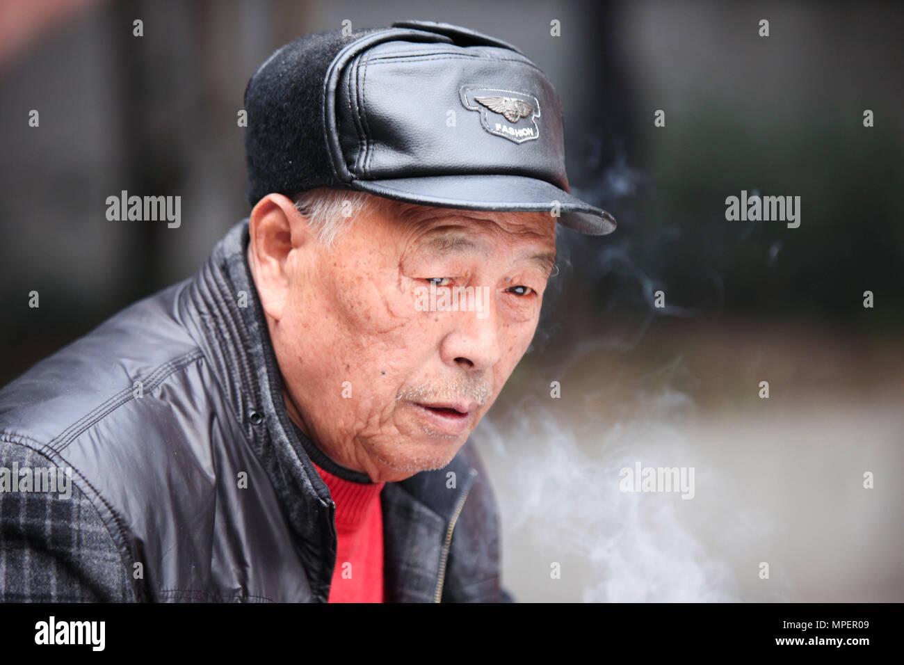 Chinese old man smoking and gambling with a cards game in Hangzhou ...