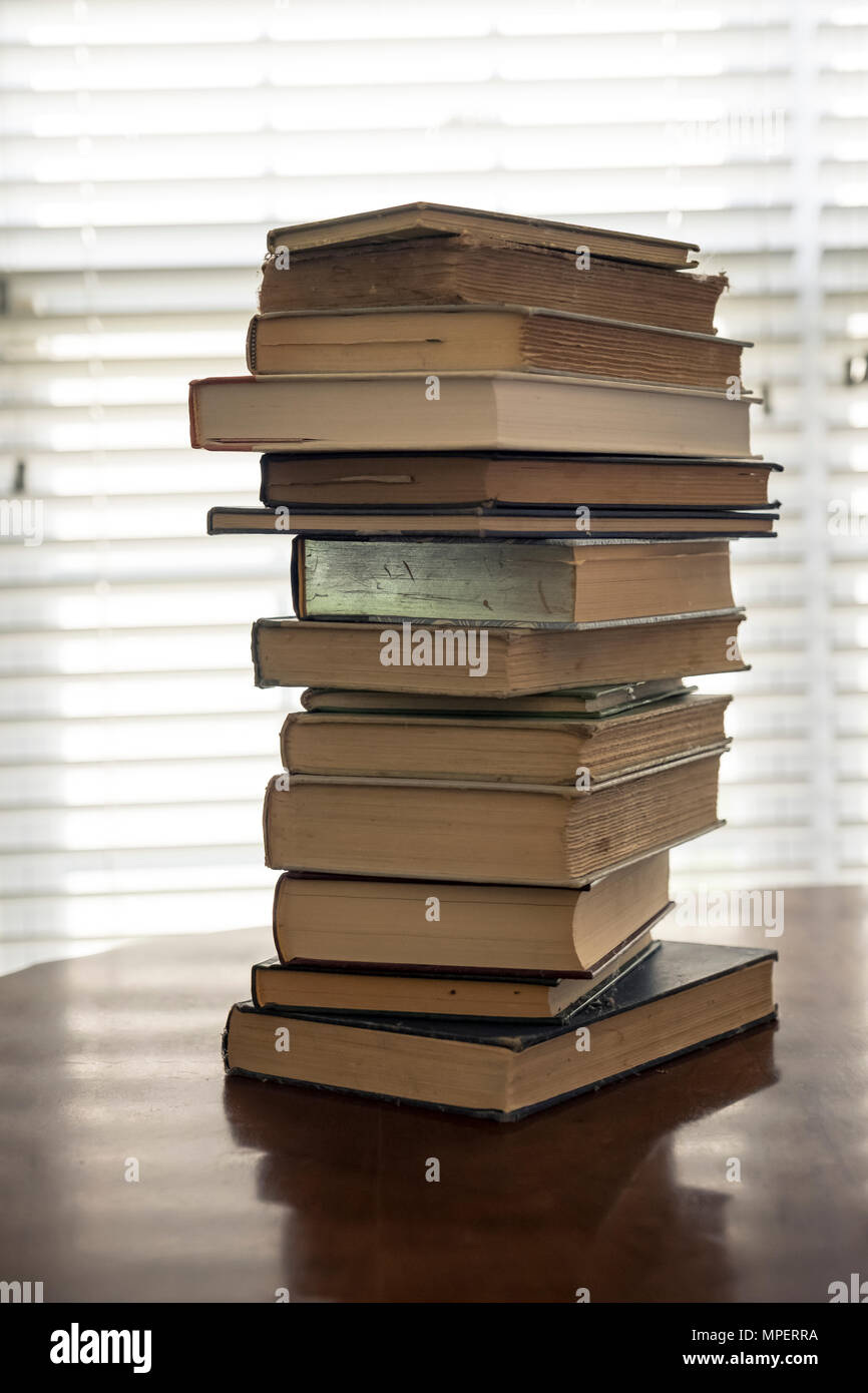 Stack of old books on kitchen table for study school in home or library ...