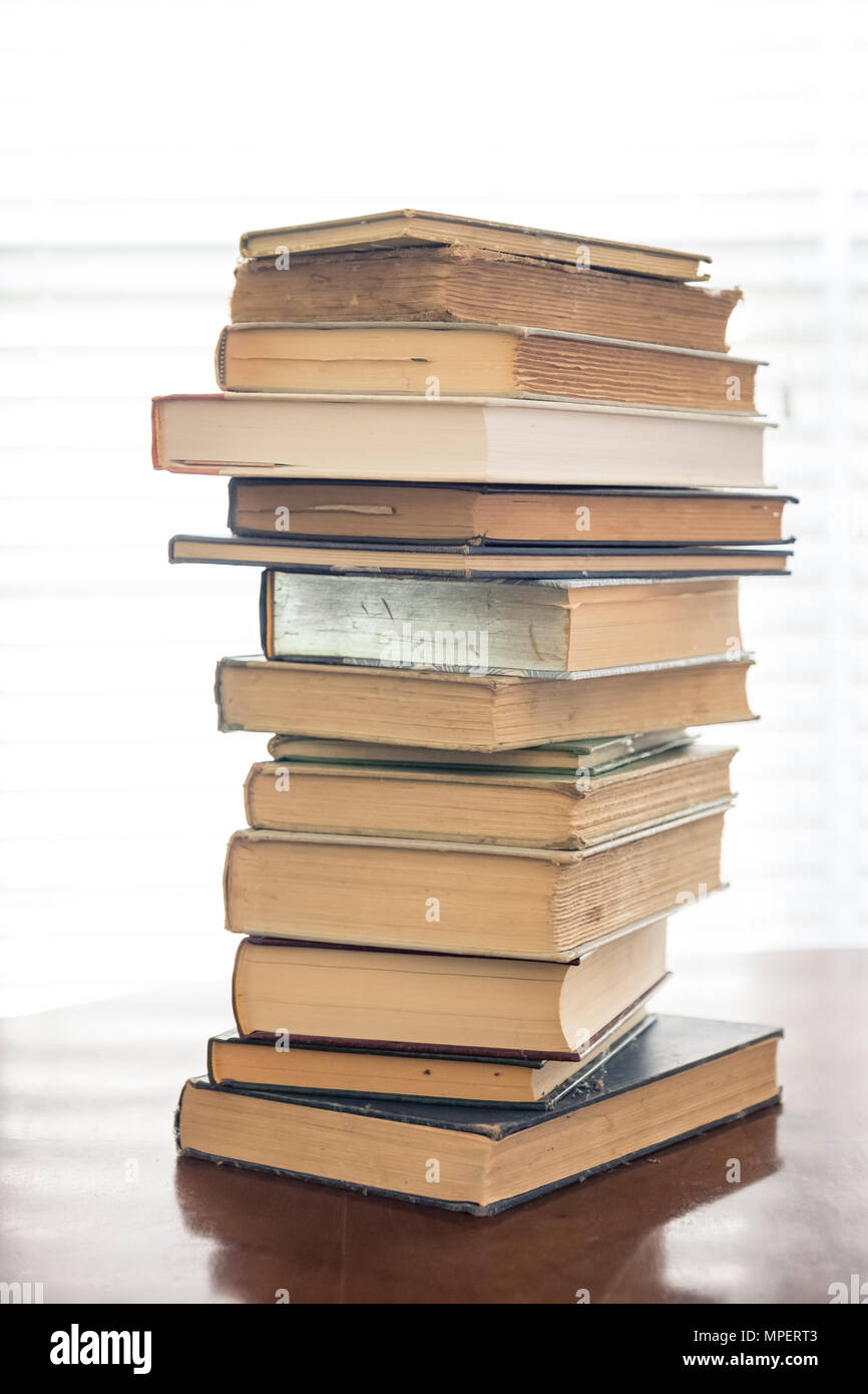 Stack of old books on kitchen table for study school in home or library ...
