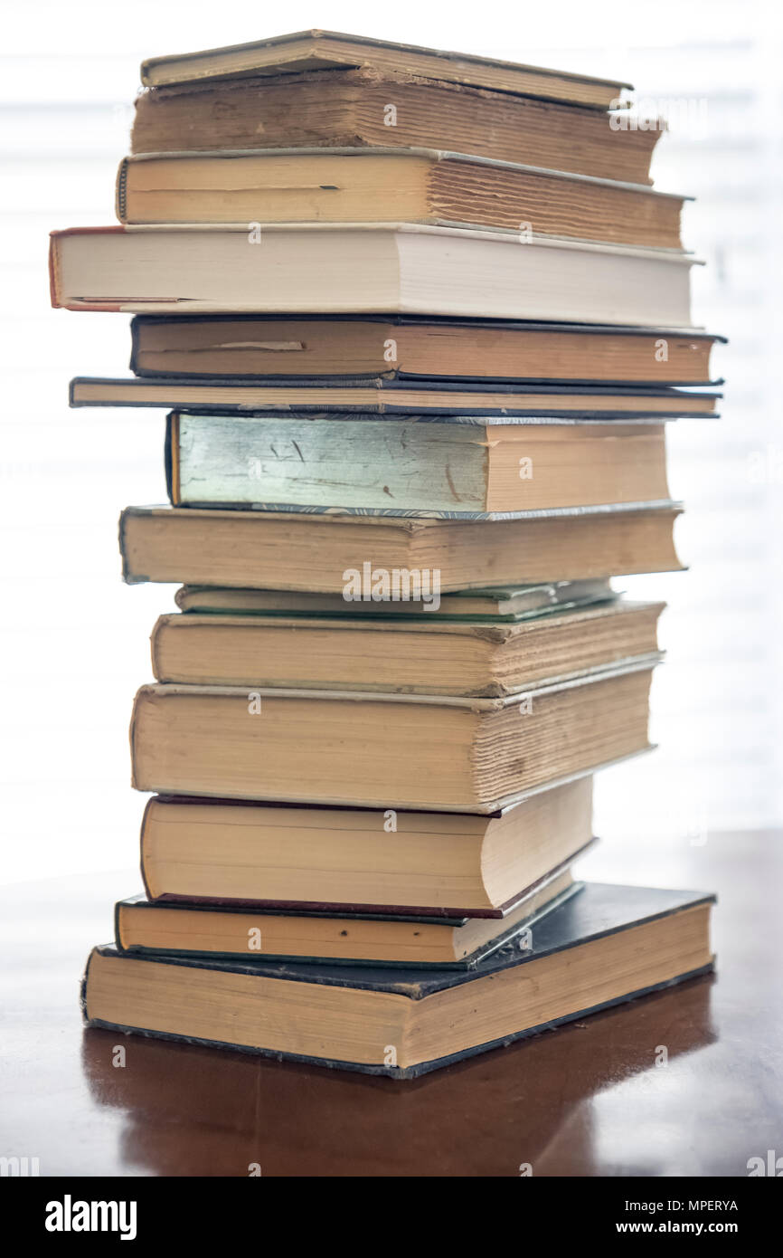 Stack of old books on kitchen table for study school in home or library ...
