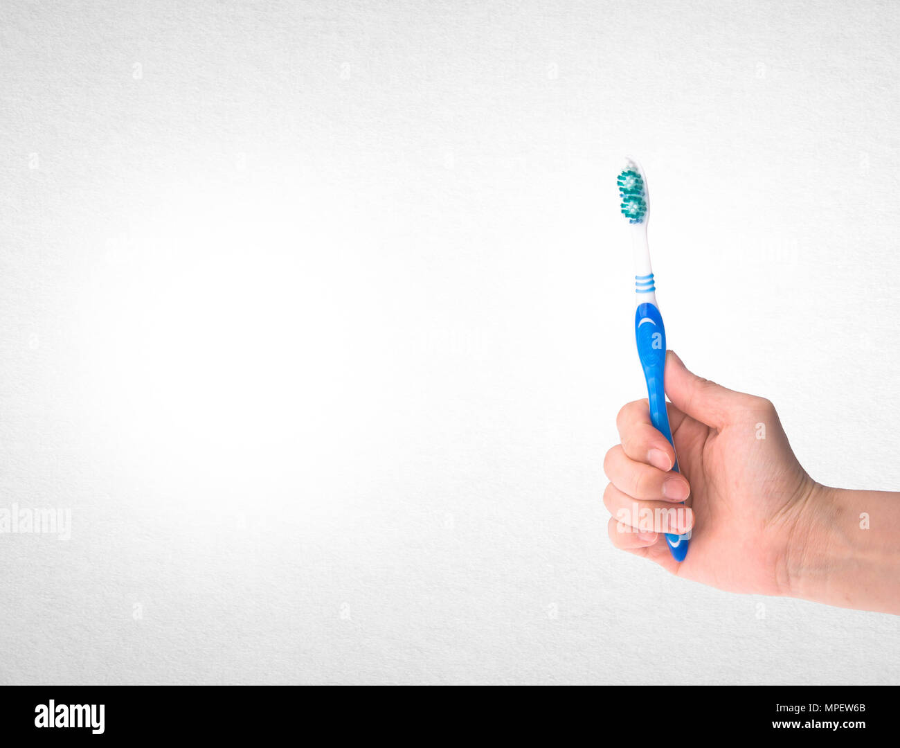 toothbrush or toothbrush in hand on background Stock Photo - Alamy
