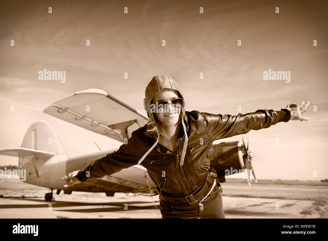 Happy young woman with raised hands flying on airporte, Sepia photo ...