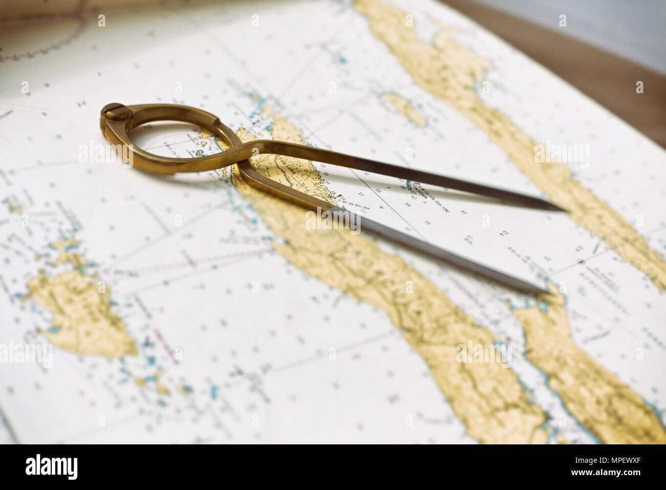 Pair of compasses for navigation on a sea map with low depth of field ...