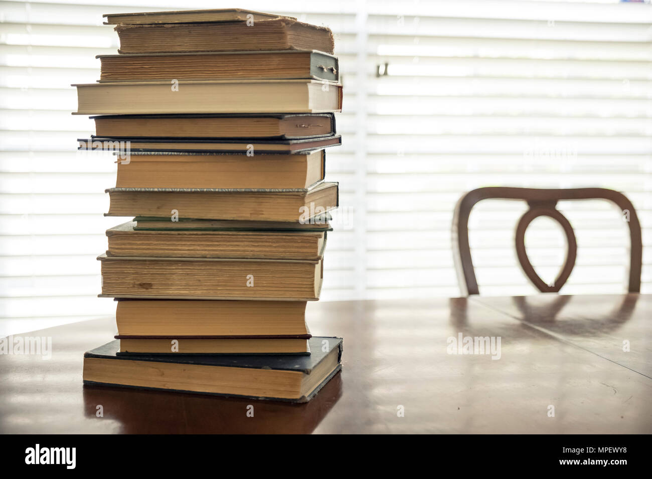 Stack of old books on kitchen table for study school in home or library ...