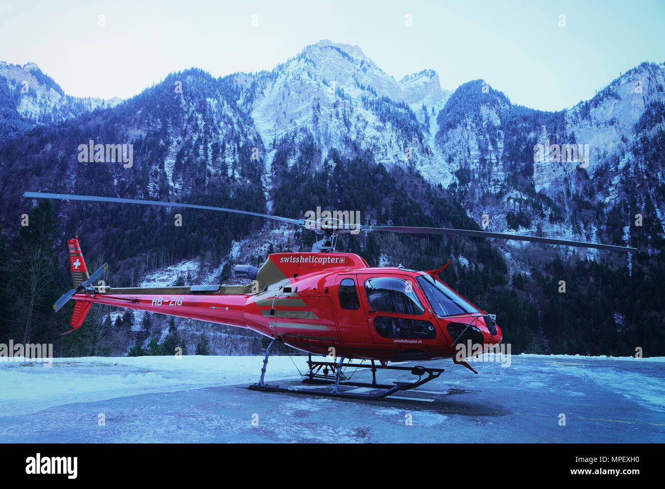 Gsteigwiler, Switzerland - December 31, 2013: Red helicopter at Swiss ...