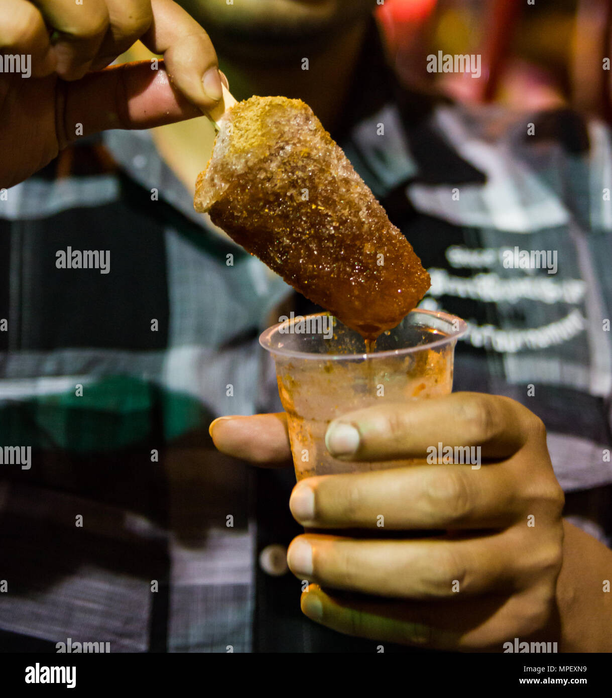 kala khatta gola held in hand crushed ice dipped on spicy syrup. indian ...