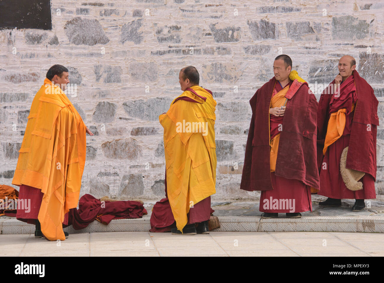 Gelukpa monks putting on their robes, Labrang Monastery, Xiahe, Gansu ...