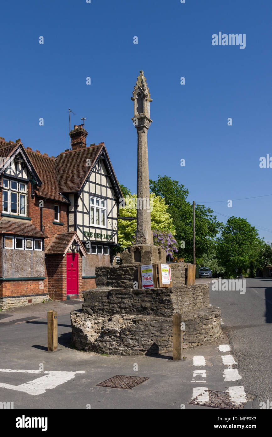 The centre of the village of Stevington with a Medieval cross believed ...