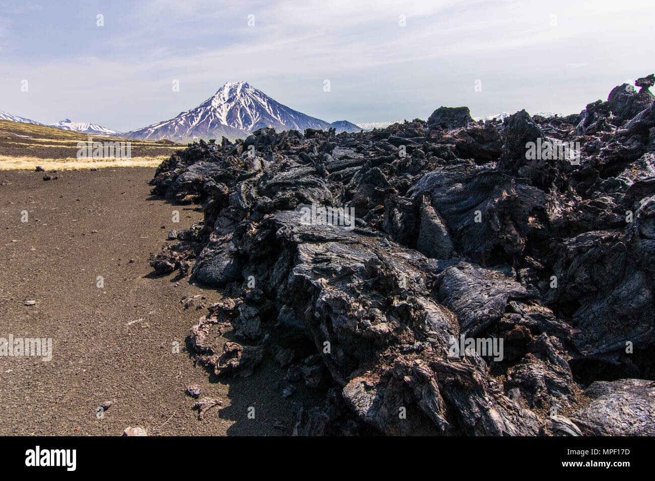 view on volcano from black volcanic sand and cold lava with few ...