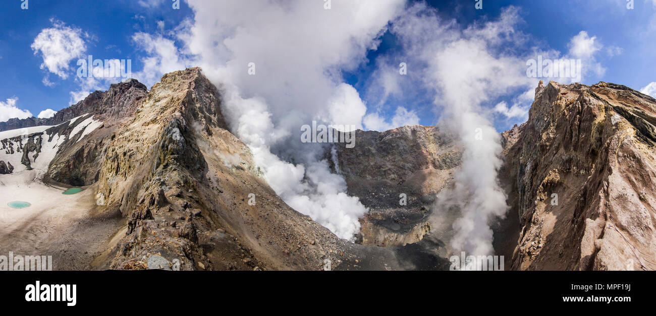 steaming crater of active volcano covered by snow Stock Photo - Alamy