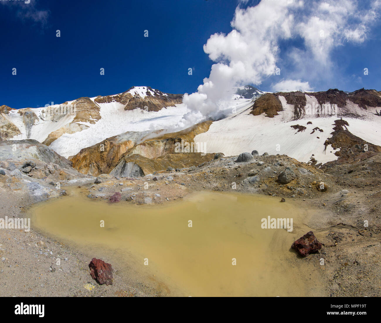 steaming crater of active volcano covered by snow Stock Photo - Alamy
