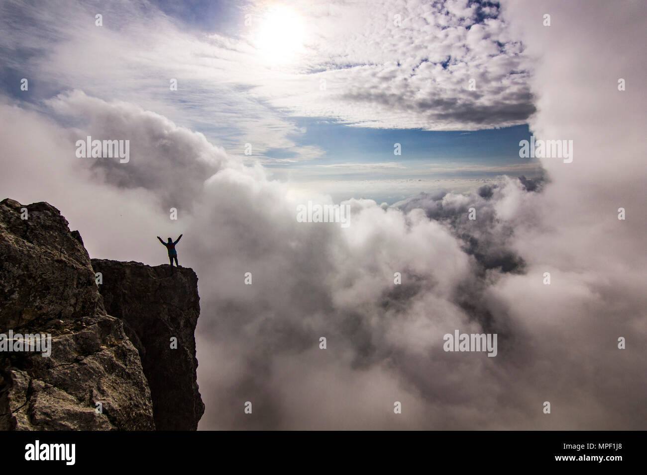 Woman rock climbing up cliff hi-res stock photography and images - Alamy