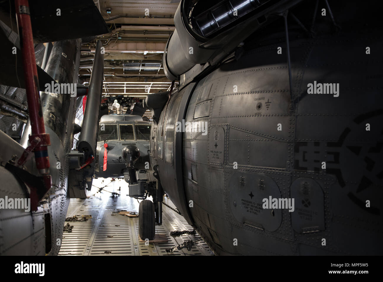 Three HH-60G Pave Hawks from the 66th Rescue Squadron are loaded into a ...
