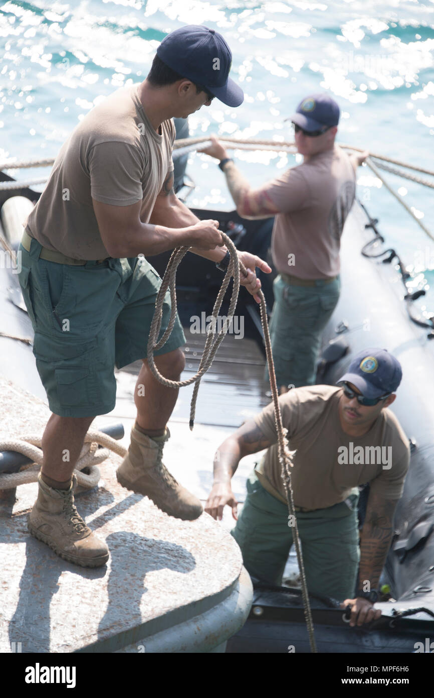 U.S. Navy Sailors, with Underwater Construction Team Two, tie off a ...