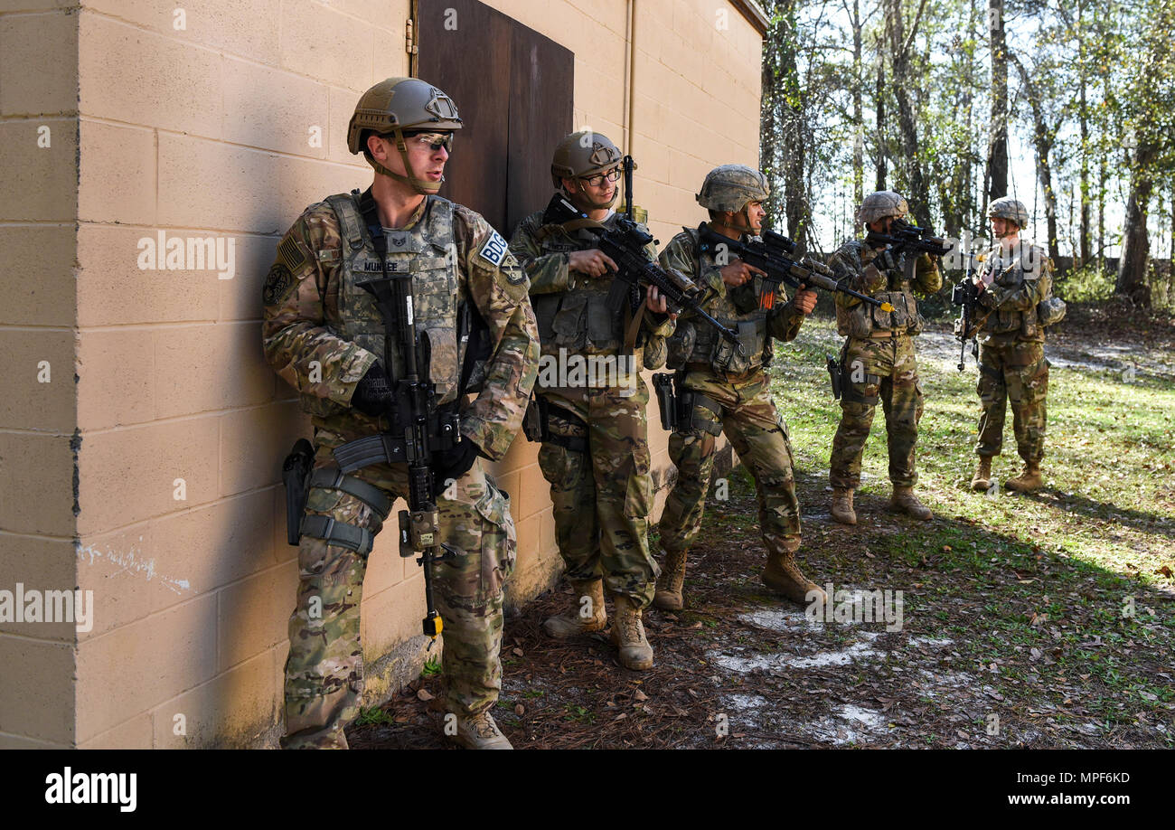 Airmen from the 822d Base Defense Squadron use a building as cover ...