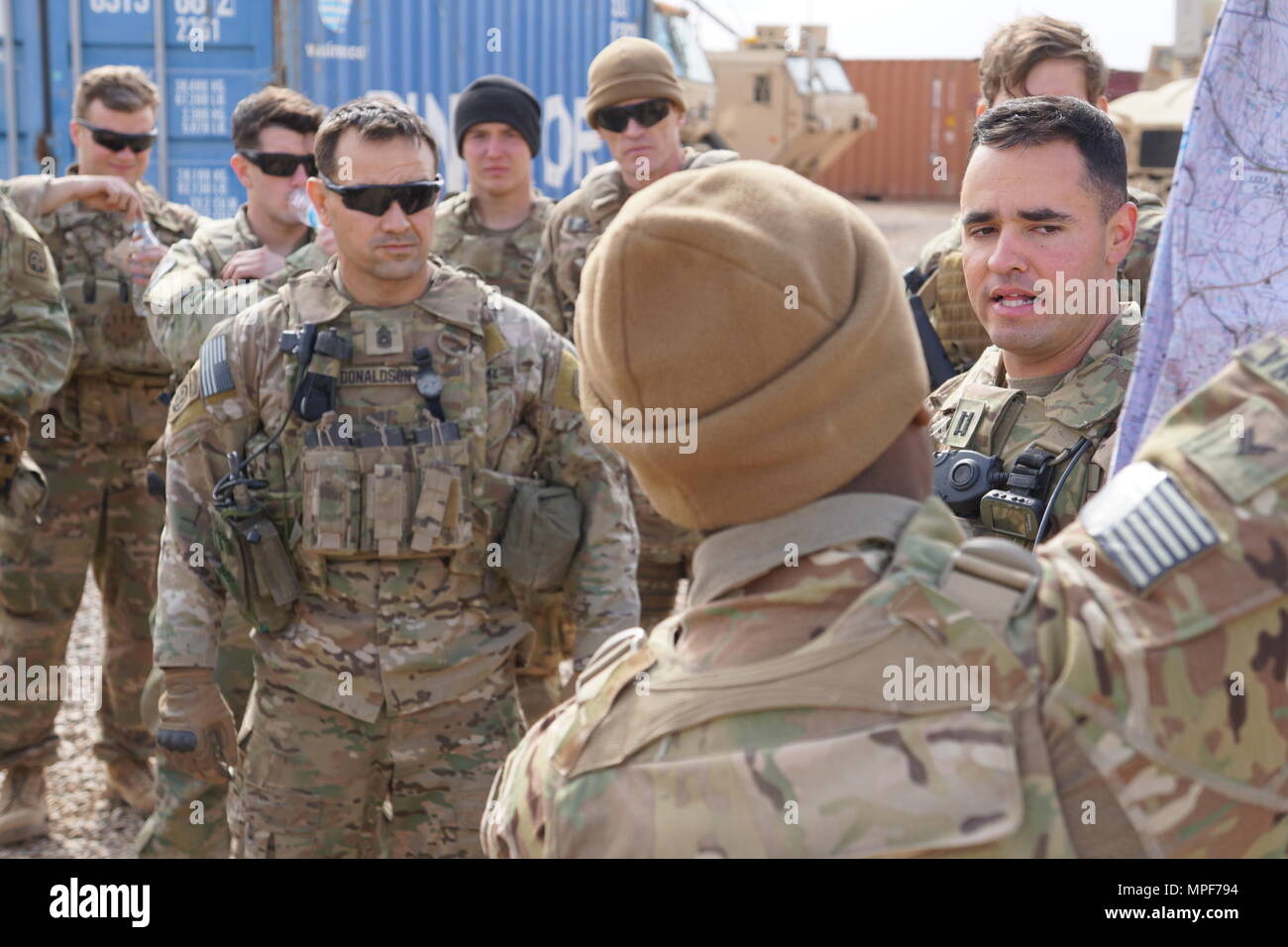 U.S. Army Sgt. Maj. Curt Donaldson (left) listens as Capt. Omar ...