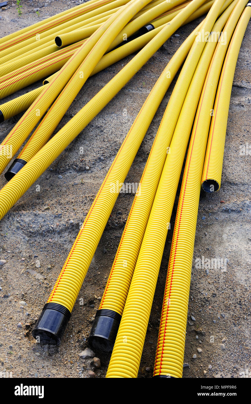 Yellow plastic tubes in the sand Stock Photo - Alamy