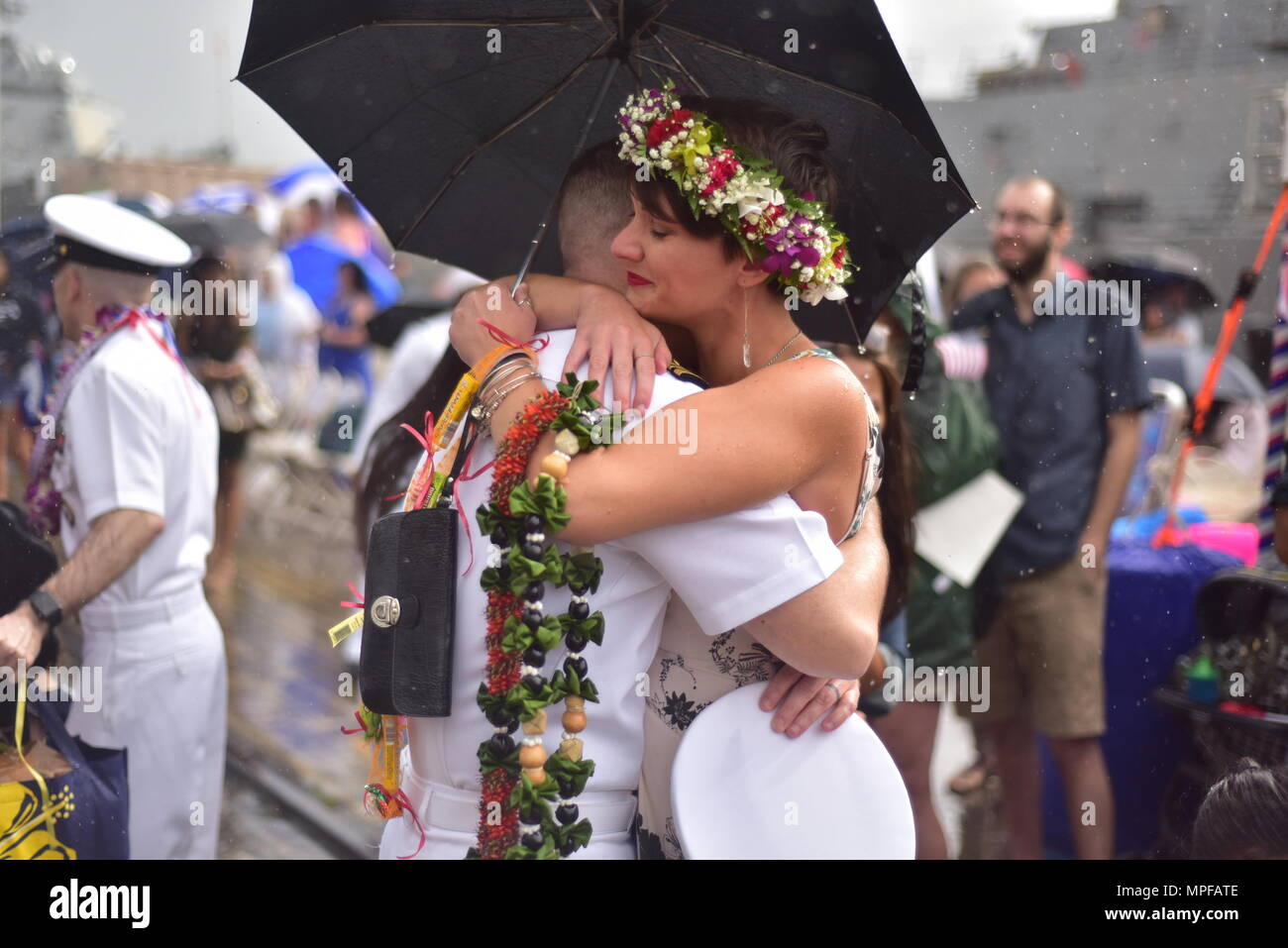 Julie Yaste embraces her husband, Lieutenant Commander Cameron Yaste ...