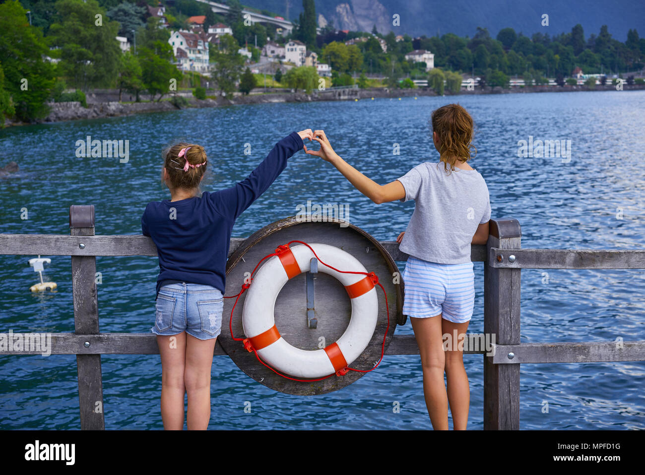 Geneve Lake Leman sister kid girl friends lifebuoy in Switzerland Swiss ...