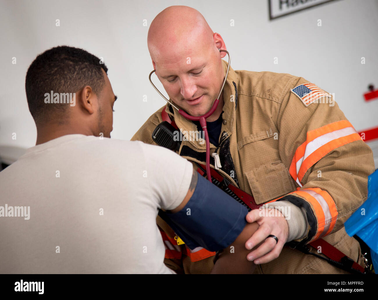 Jerry Carlton, a 96th Test Wing firefighter, checks blood pressure and ...