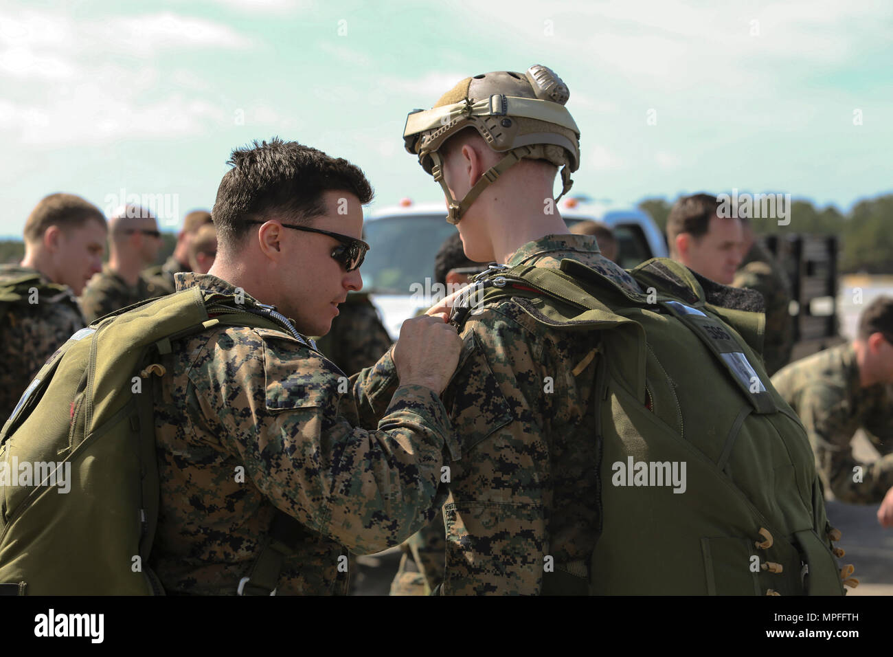 Marines conduct one last check for the integrity of their parachutes ...