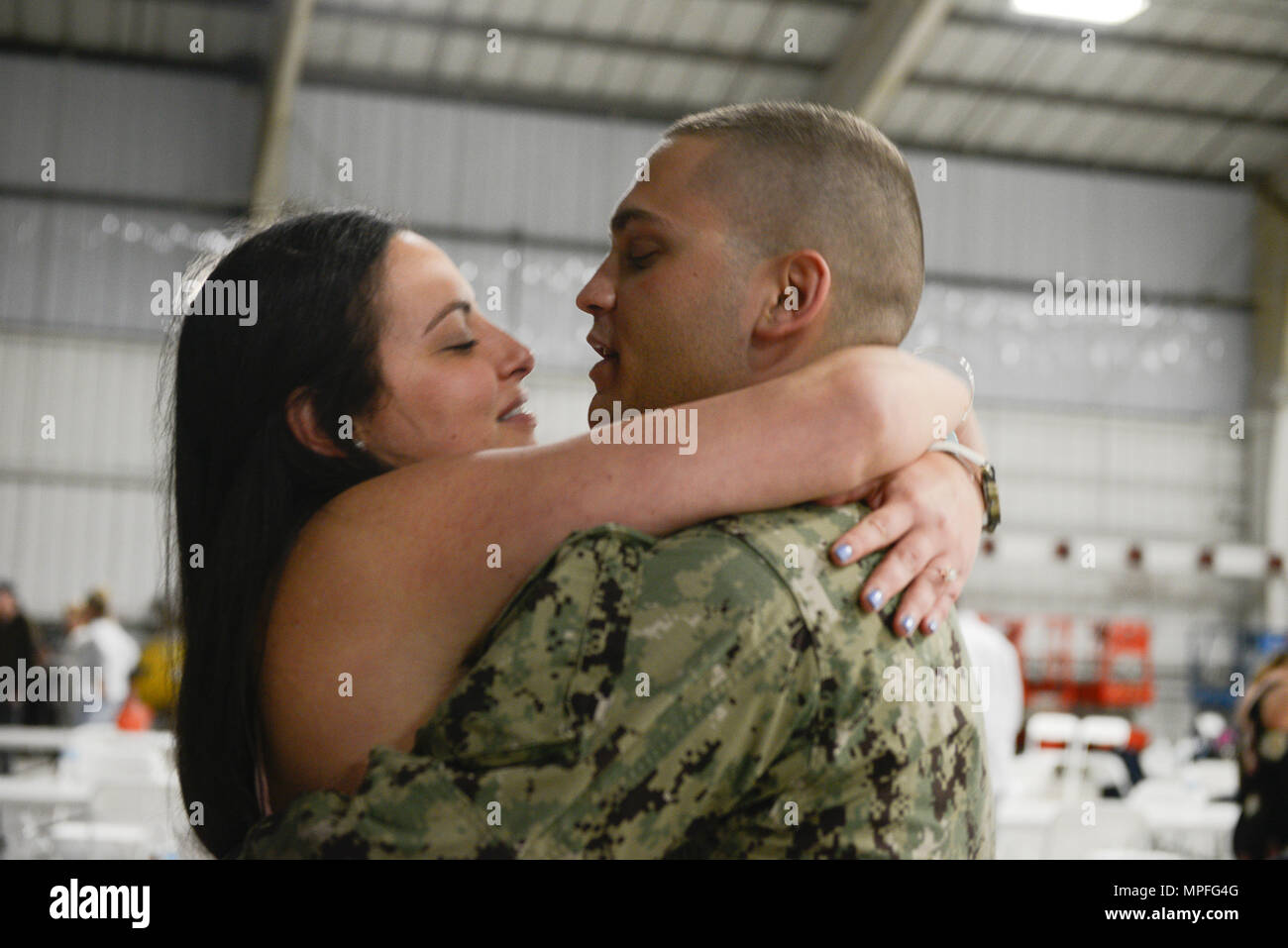 A Port Security Unit 307 member embraces a loved one after returning ...