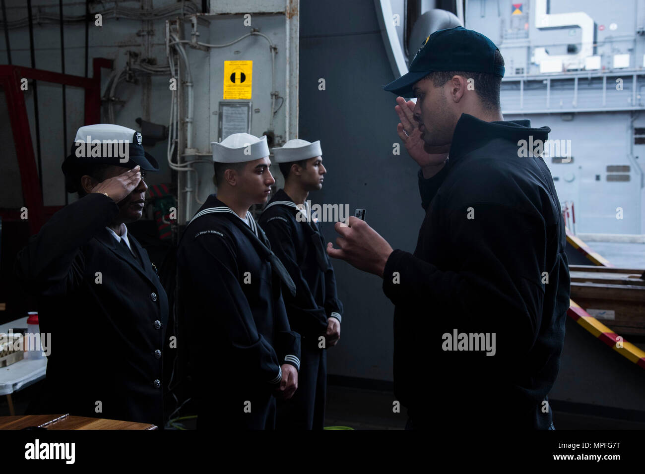 Aviation Maintenance Administrationman authorizes a Sailor to go ashore ...