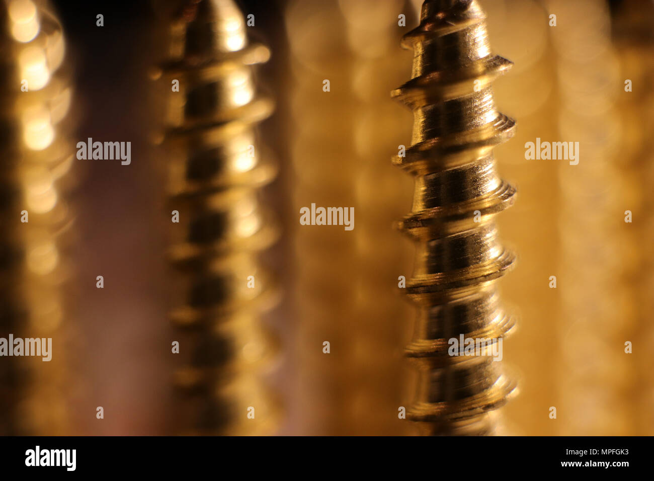 Golden screws hi-res stock photography and images - Alamy