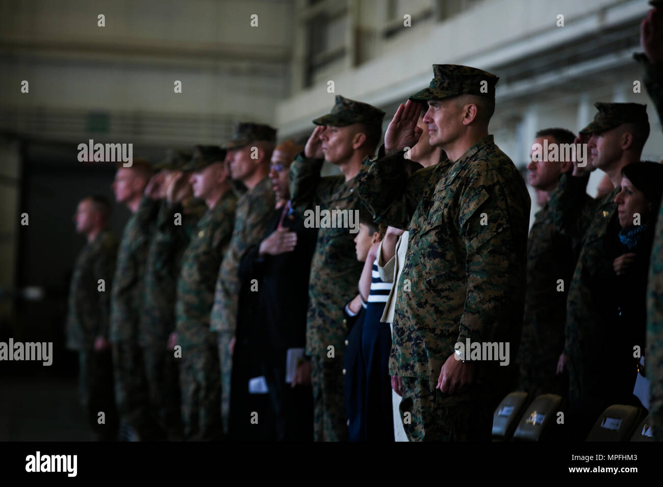 Col. Sean Salene salutes during the National Anthem at his change of ...