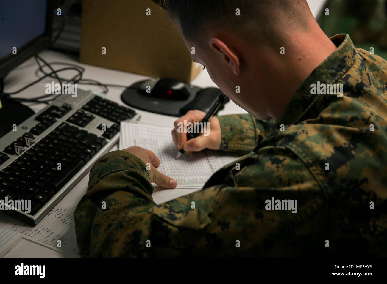 Lance Cpl. Joshua Kauffman reviews discrepancy forms before sending the ...