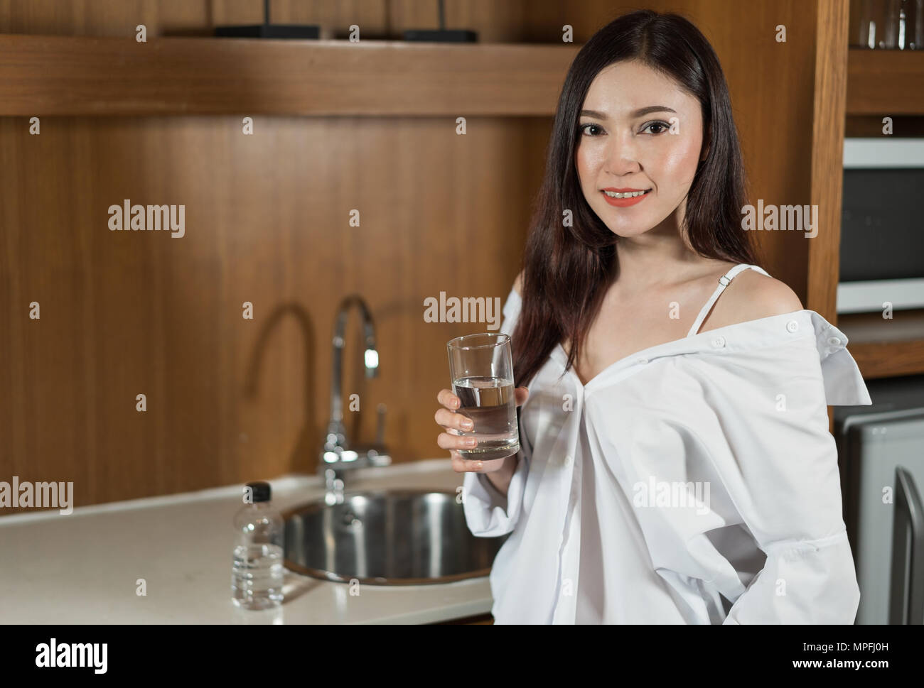 Woman drinking water kitchen hi-res stock photography and images - Alamy