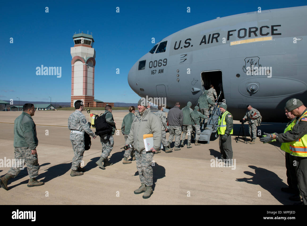 Airmen from the 167th Airlift Wing board a C-17 Globemaster III ...
