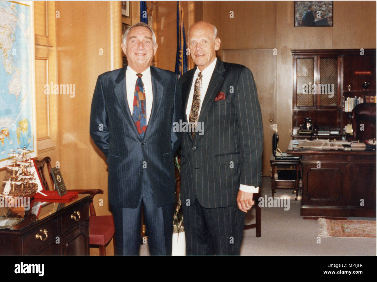 TWO MEN ARE STANDING TOGETHER IN A OFFICE TAKING A PICTURE Stock Photo ...