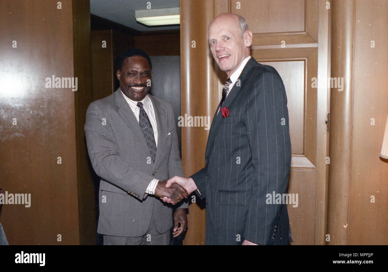 TWO MEN GREETING EACH OTHER WITH A HAND SHACK AND A SMILE Stock Photo ...
