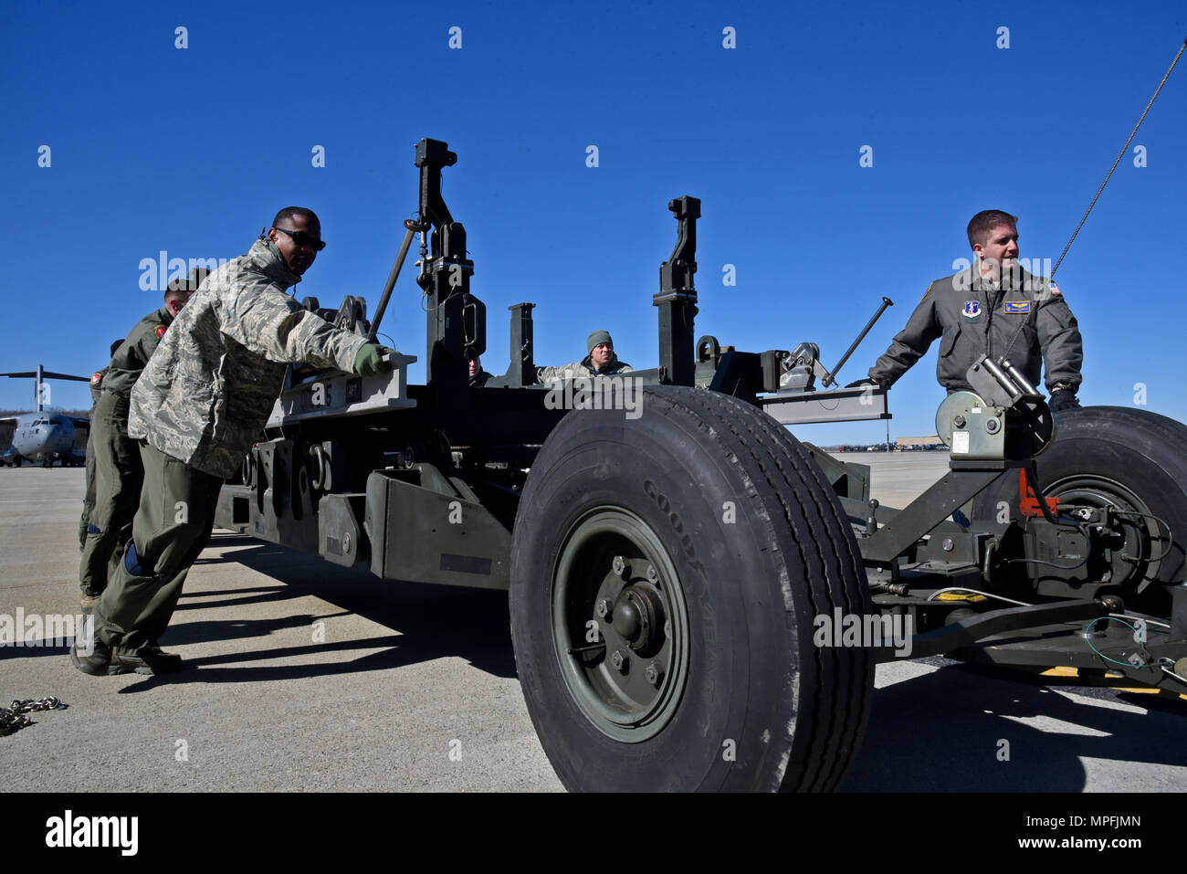 Airmen with the 137th Airlift Squadron practice loading and unloading a ...