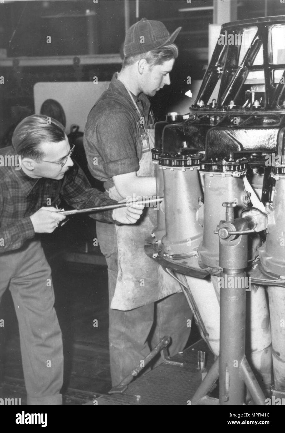 Mechanics works on an Allison J33 jet engine inside the Oklahoma City ...