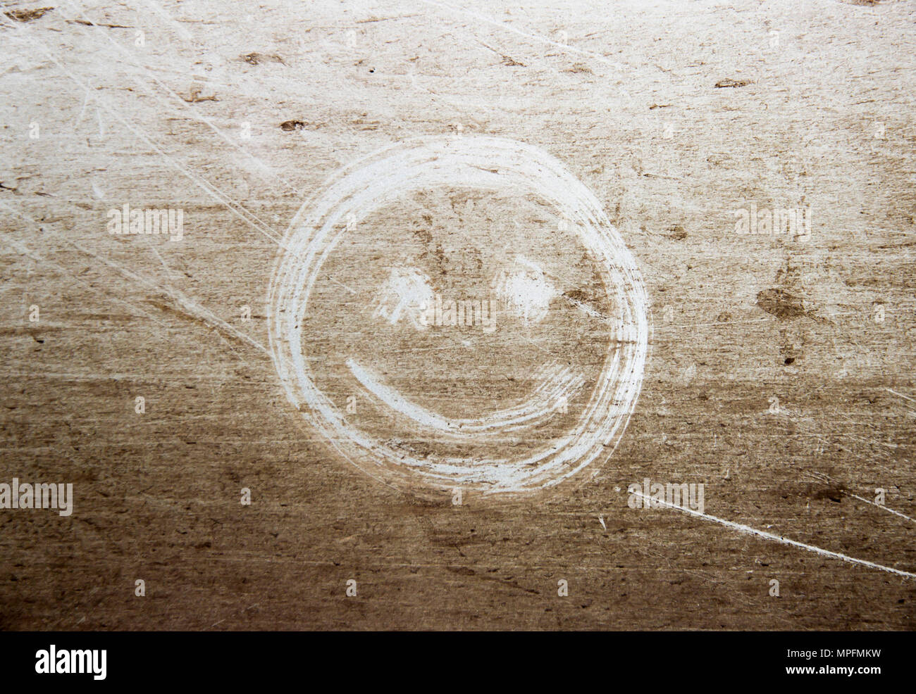 Cheerful smiley on dusty surface closeup Stock Photo - Alamy