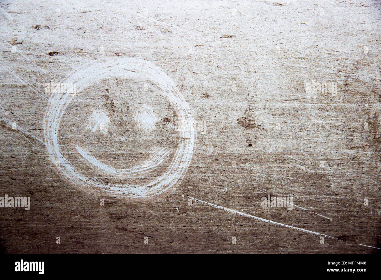 Cheerful smiley on dusty surface closeup Stock Photo - Alamy