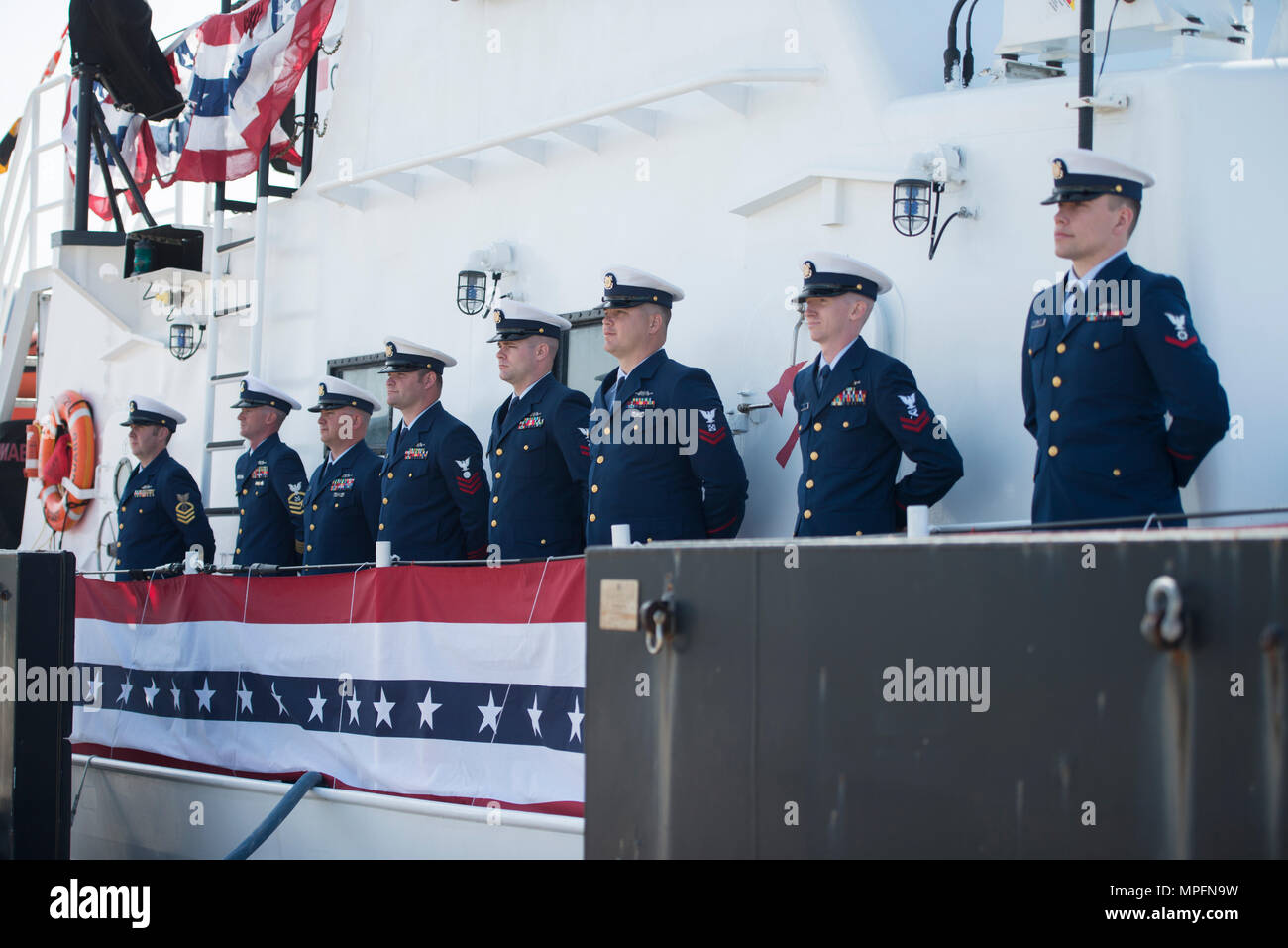 The crew of Coast Guard Cutter Cushing stands at parade rest during the ...