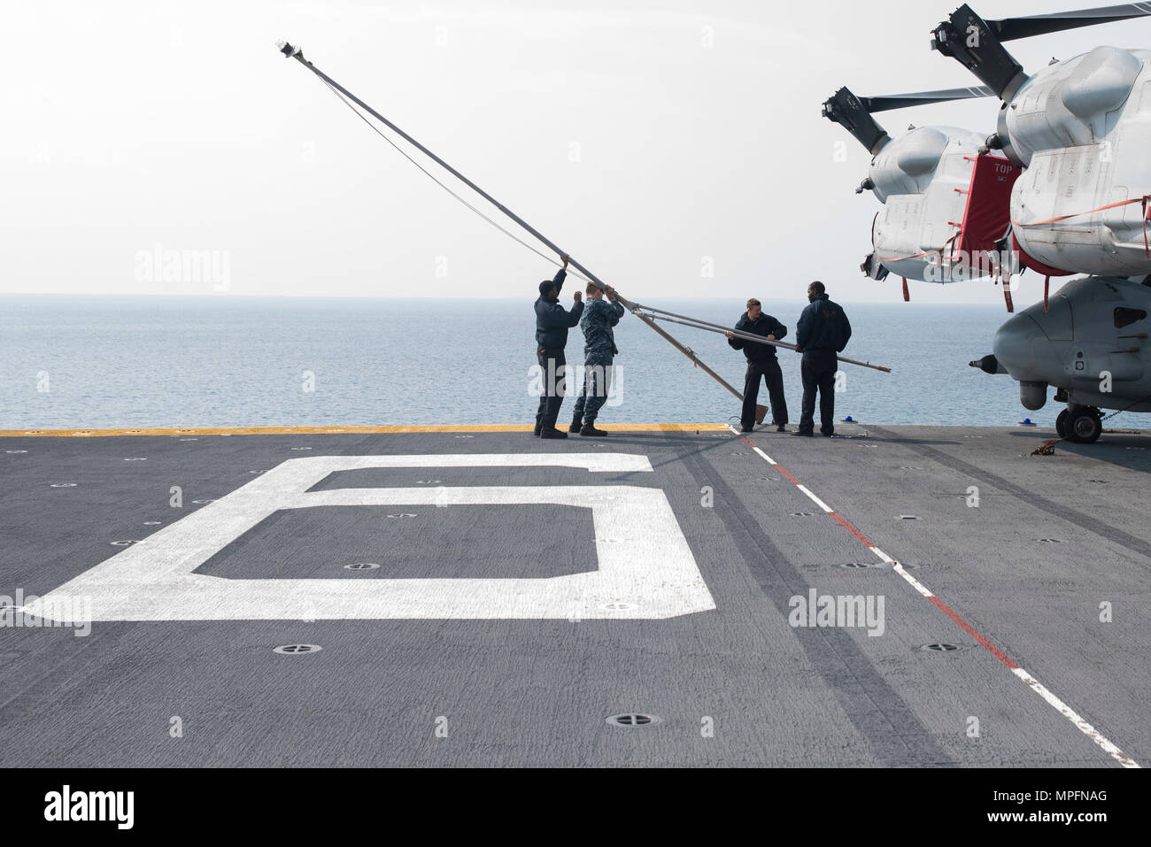 170308-N-XT039-124 OKINAWA, Japan (March 8, 2017) Sailors lower the ...