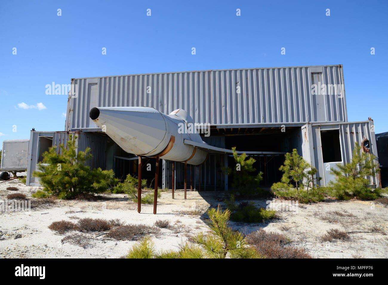 A sheet metal fabricated aircraft shape is parked under a simulated ...