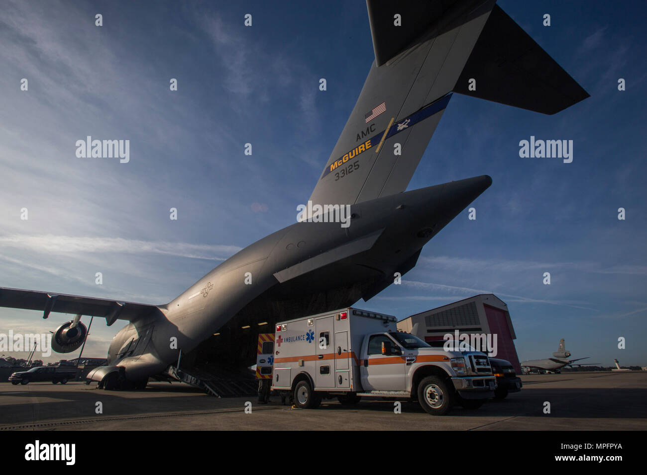 An ambulance pulls up to a 305th Air Mobility Wing C-17 Globemaster III ...